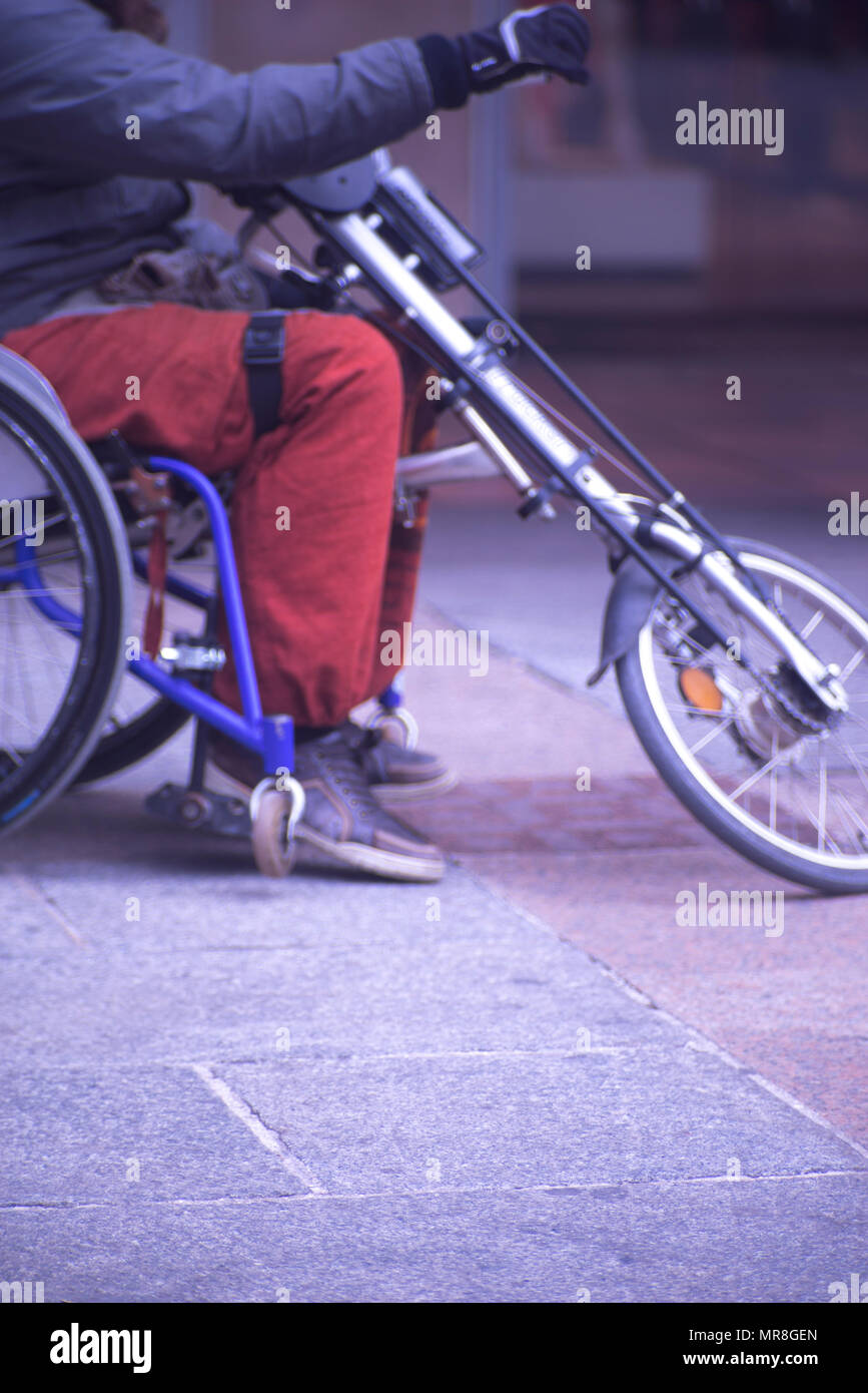 Man in cool looking motorbike chopper style wheelchair in urban city ...