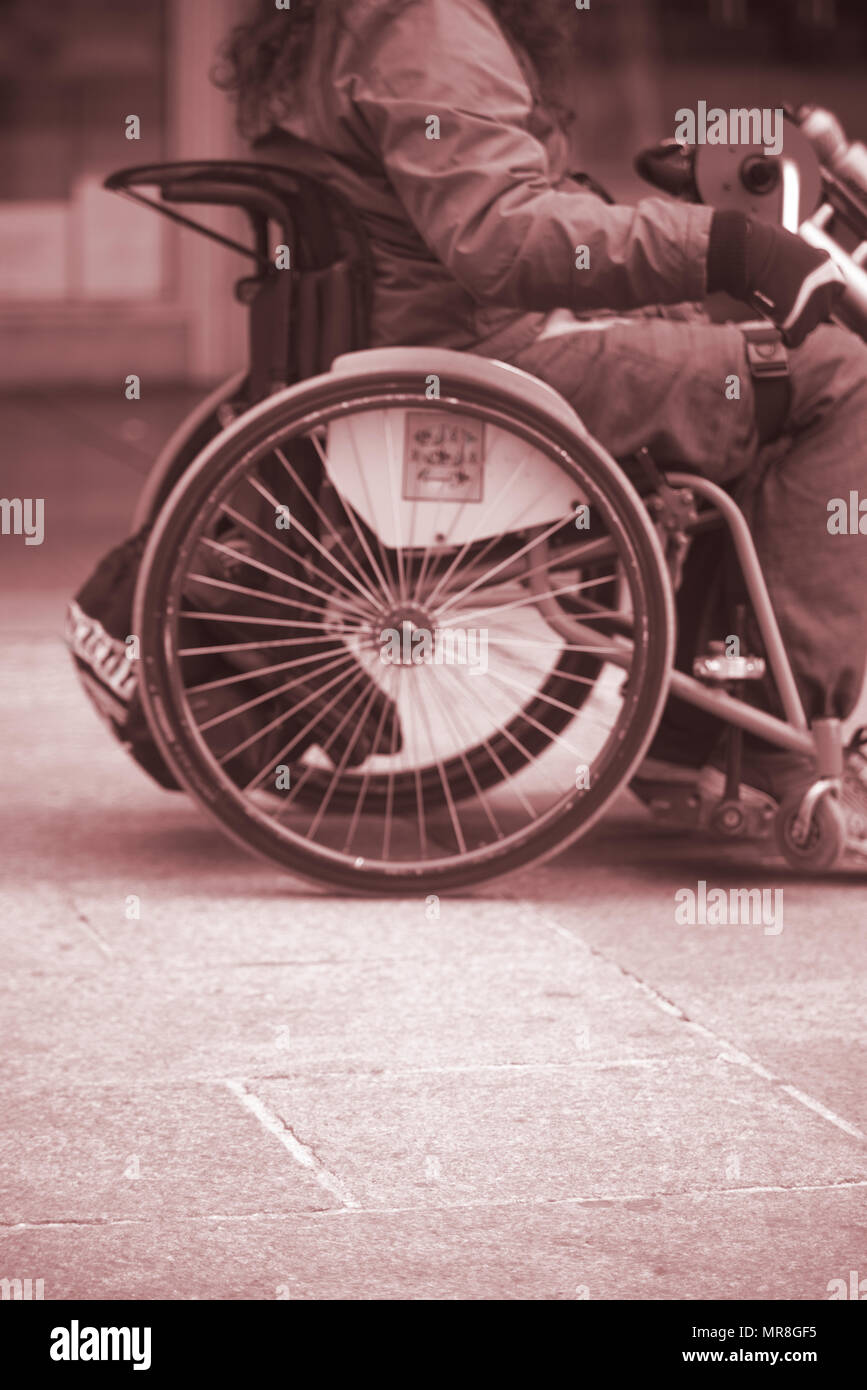 Man in cool looking motorbike chopper style wheelchair in urban city ...