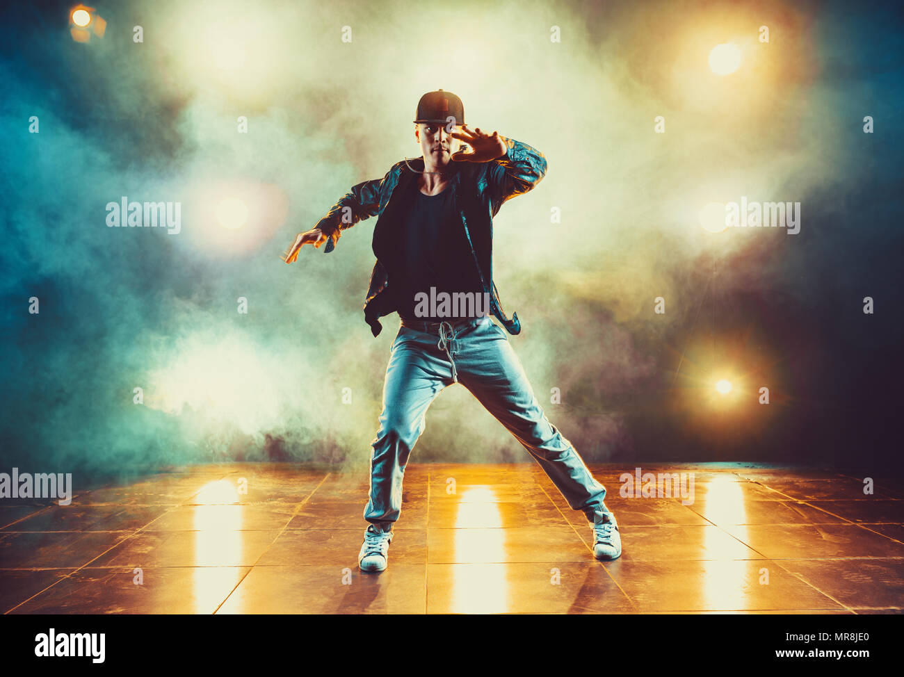Young man break dancing in club with lights and smoke Stock Photo - Alamy