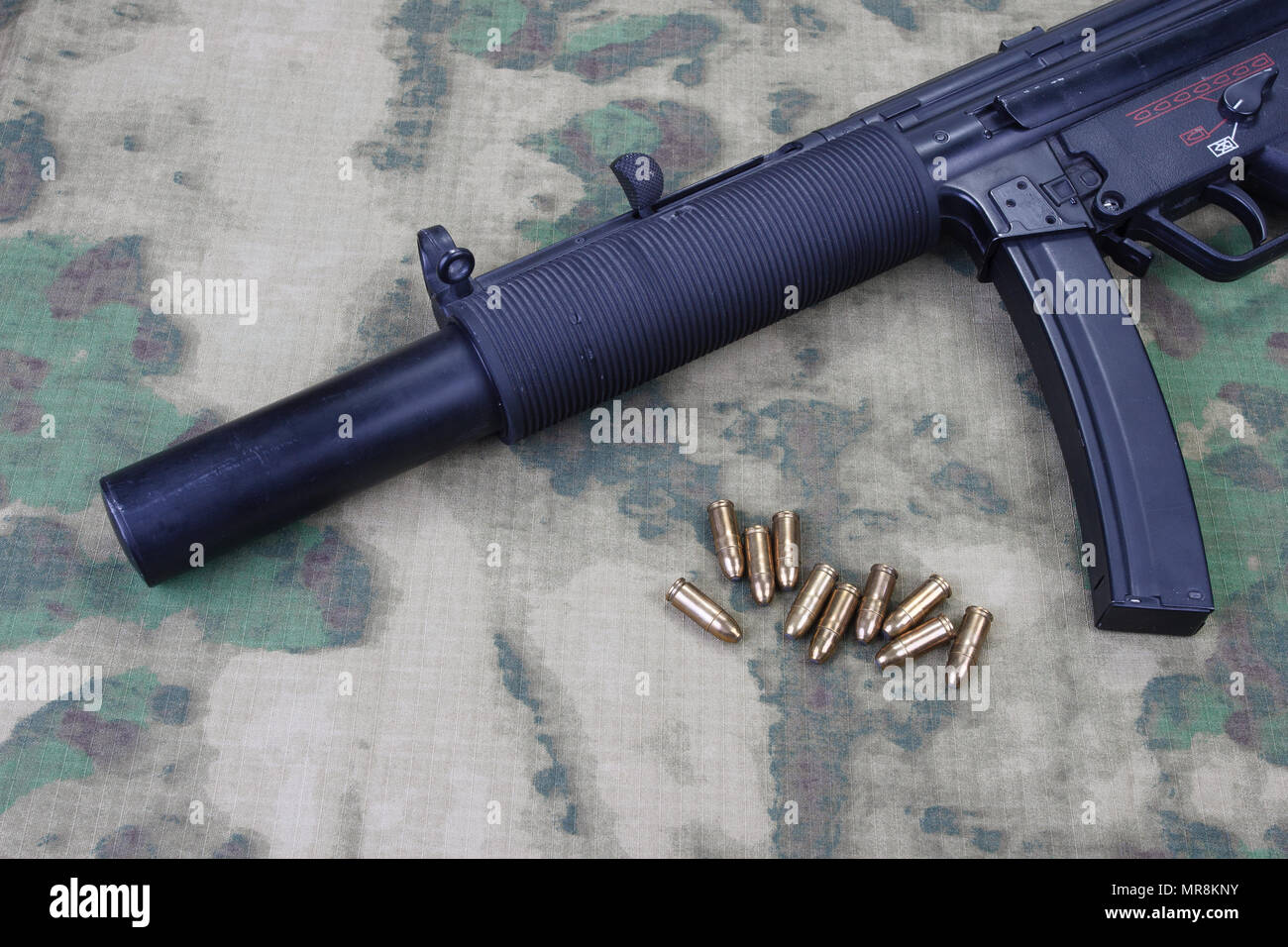 submachine gun MP5 with silencer on camouflaged background Stock Photo ...