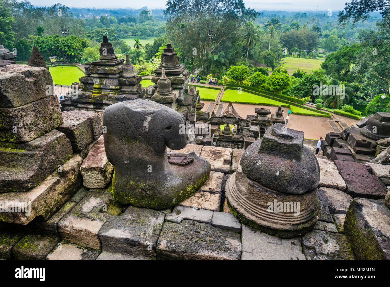 a headless Buddha statue at a balustrade of the 9th century Borobudur ...