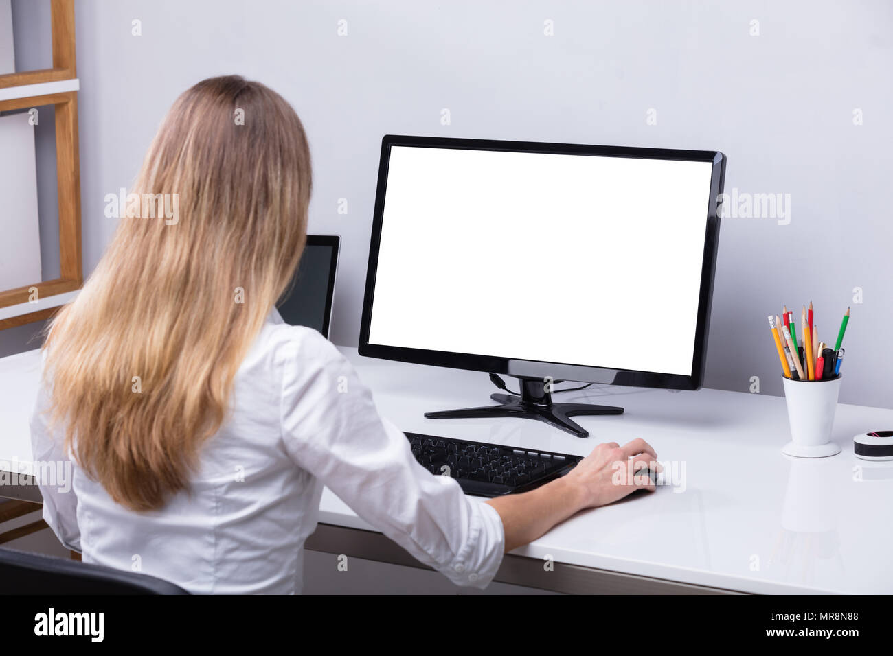 Businesswoman Using Computer With Blank White Screen At Workplace Stock ...