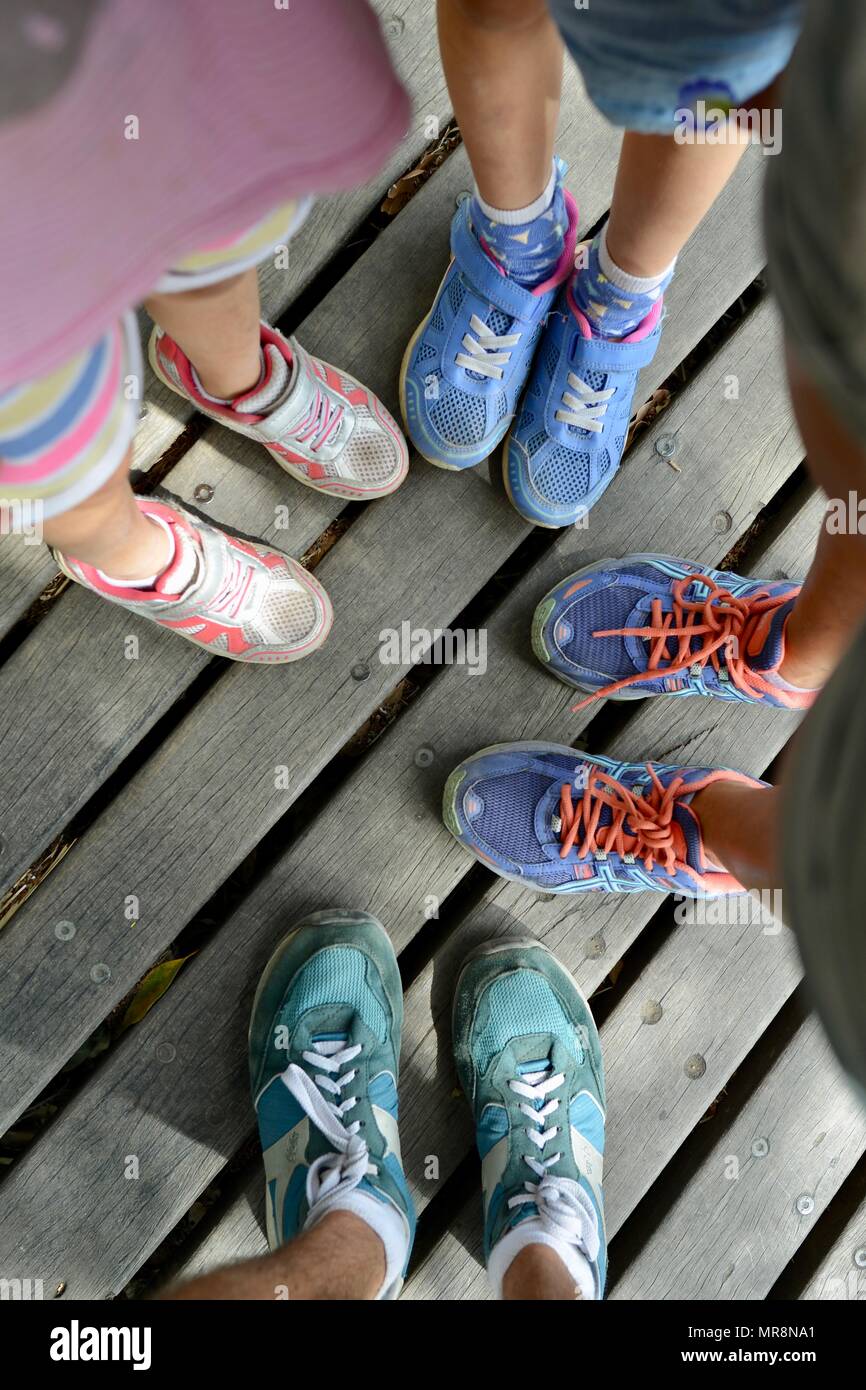 Four sets of feet of two children and two adults hi-res stock ...