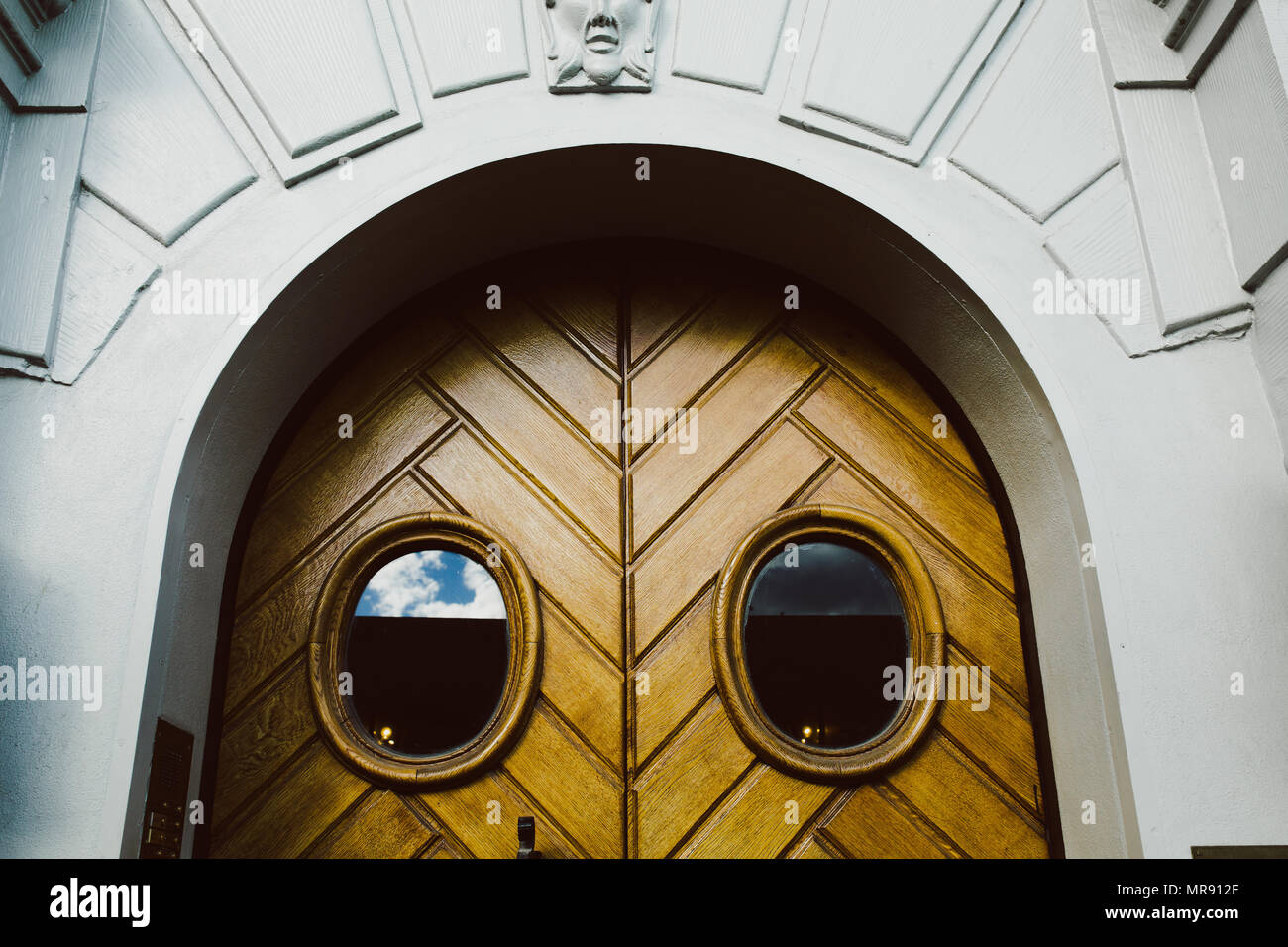 wooden doors with round windows in beautiful building in stockholm ...