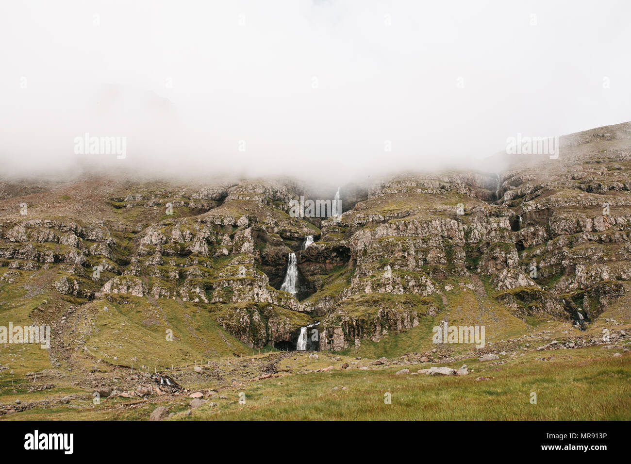 beautiful icelandic landscape with scenic waterfall on rocky slope in ...