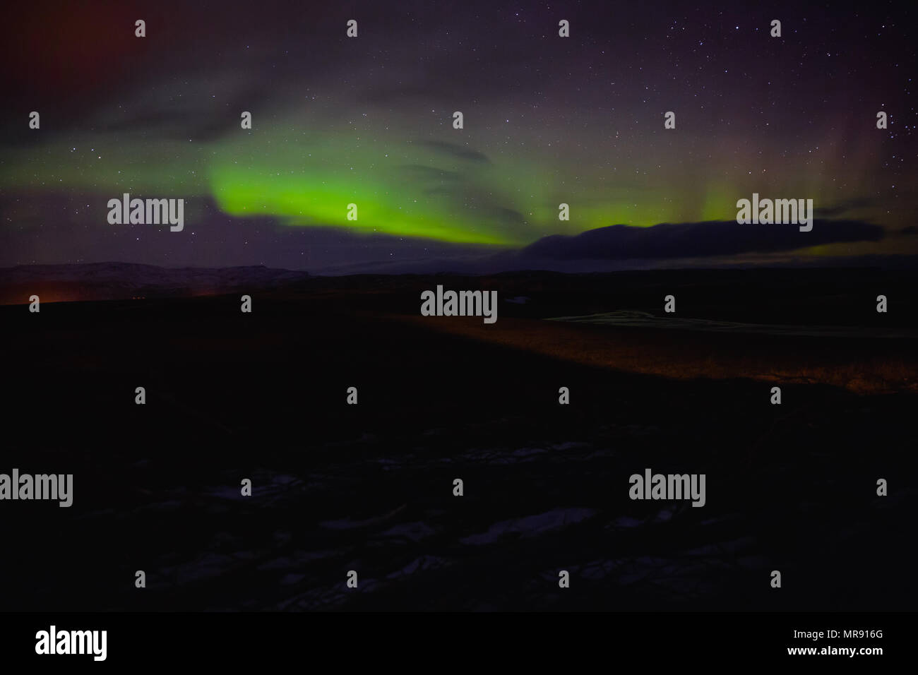 majestic view of night sky with aurora borealis and stars in iceland ...