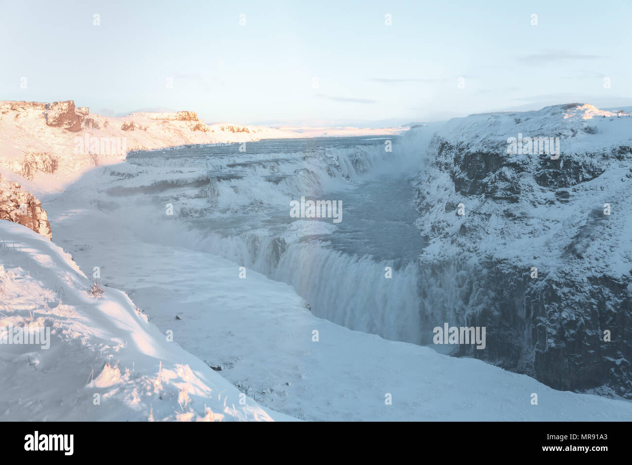 beautiful icelandic landscape with snow-covered rocks and Gullfoss ...