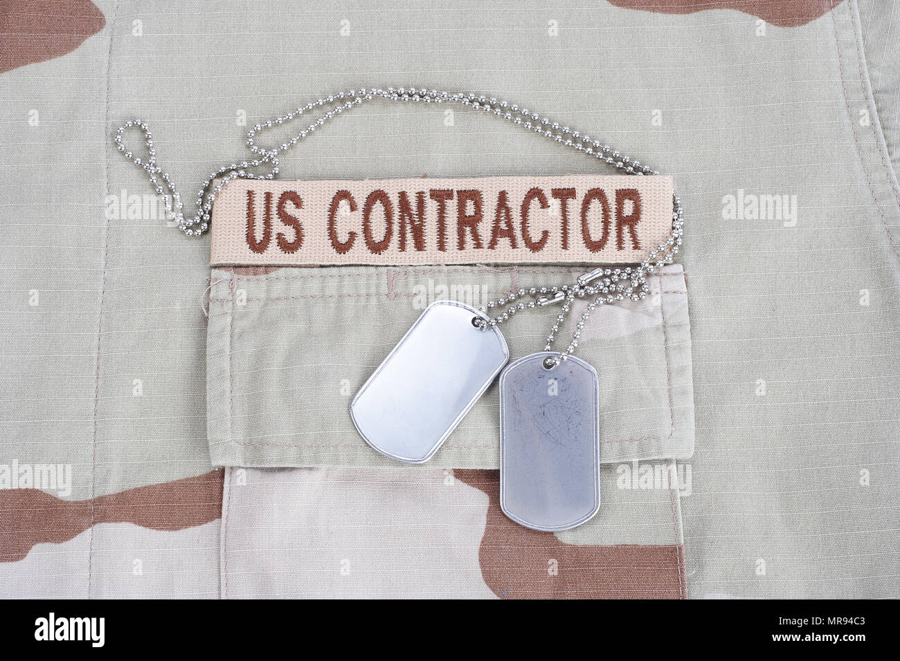 KIEV, UKRAINE - June 14, 2015. US CONTRACTOR branch tape with dog tags ...