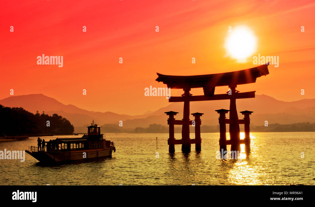 Torii gate during sunset at Miyajima, Japan Stock Photo - Alamy