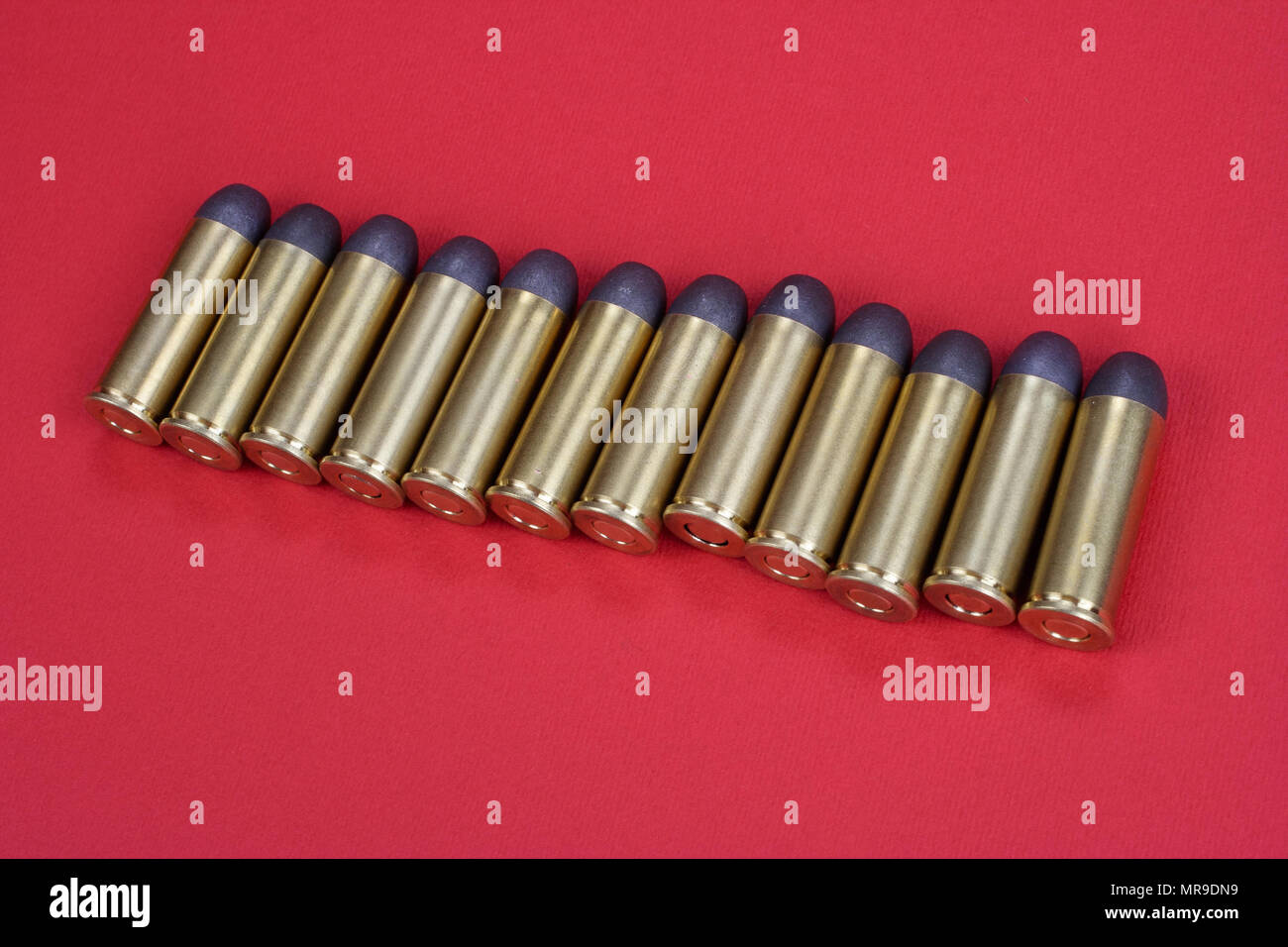 The .45 Revolver cartridges Wild West period on red background Stock ...
