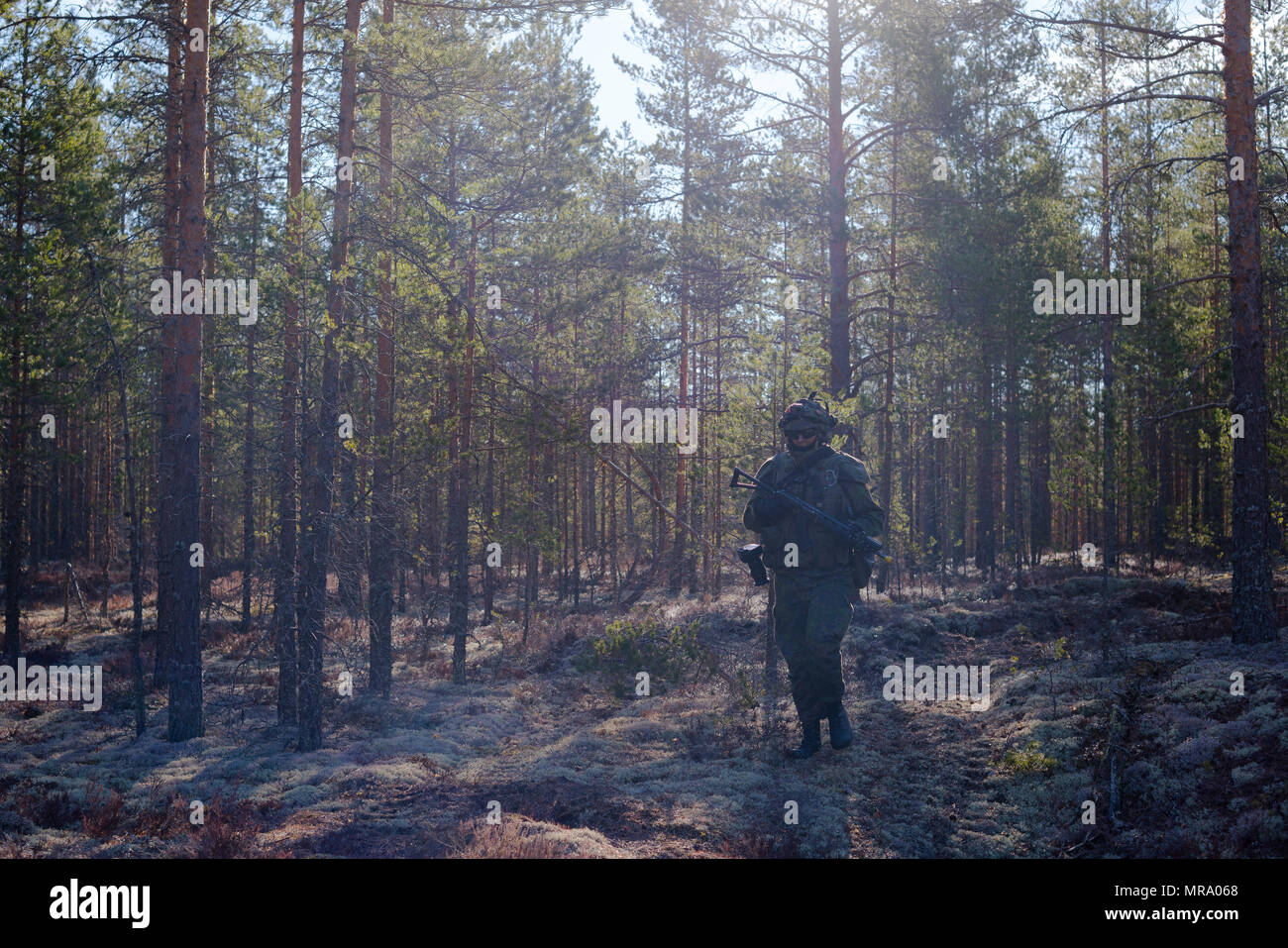 Sgt. Alex Heihonen, a Finnish combat camera soldier, patrols the area ...