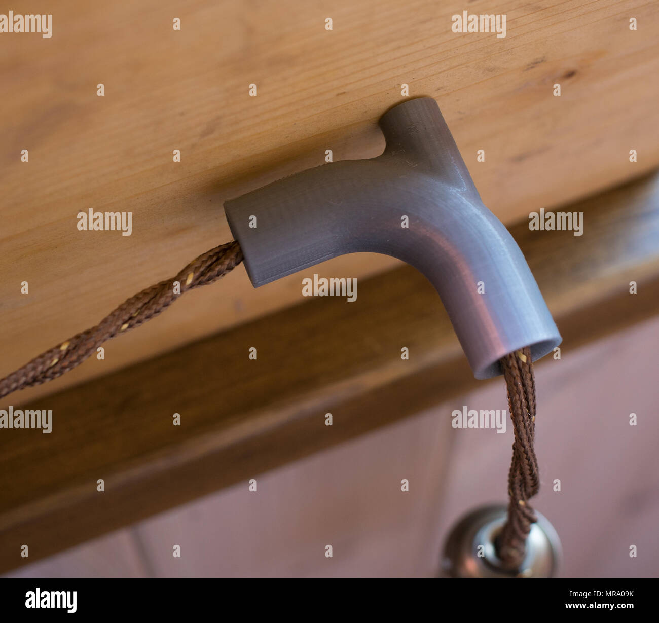 Vintage wire cable plastic holder on the wooden wall Stock Photo - Alamy