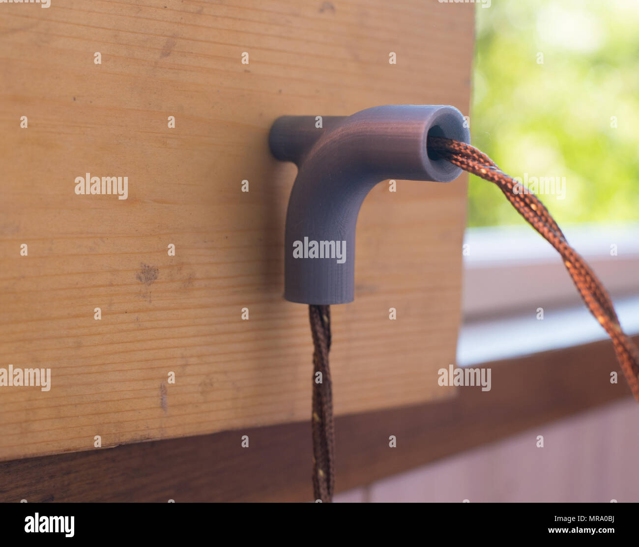 Vintage wire cable plastic holder on the wooden wall Stock Photo - Alamy