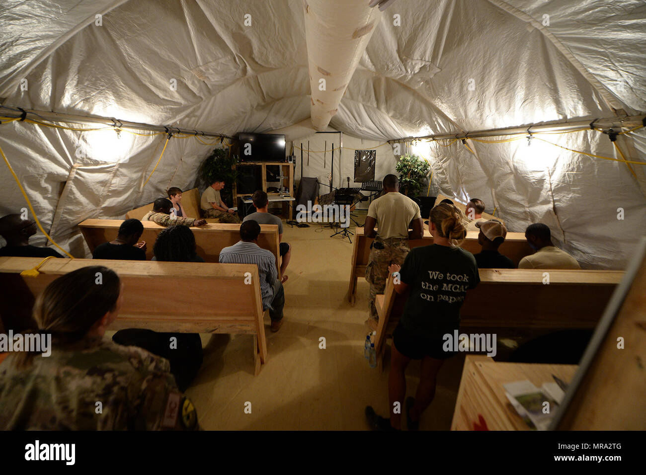 Airmen deployed to the 724th Expeditionary Air Base Squadron listen to ...