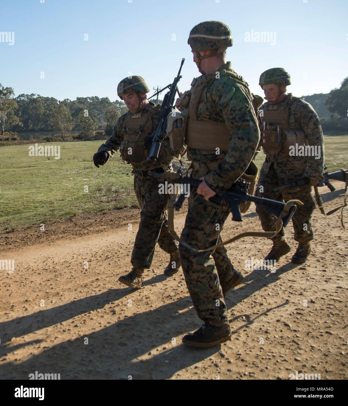U.S. Marines Sgt. Brian Stiles (left) hands off the M249 to Cpl. John ...