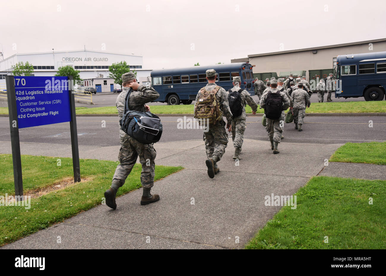 Airmen from the 142nd Fighter Wing prepare to load up on buses to ...