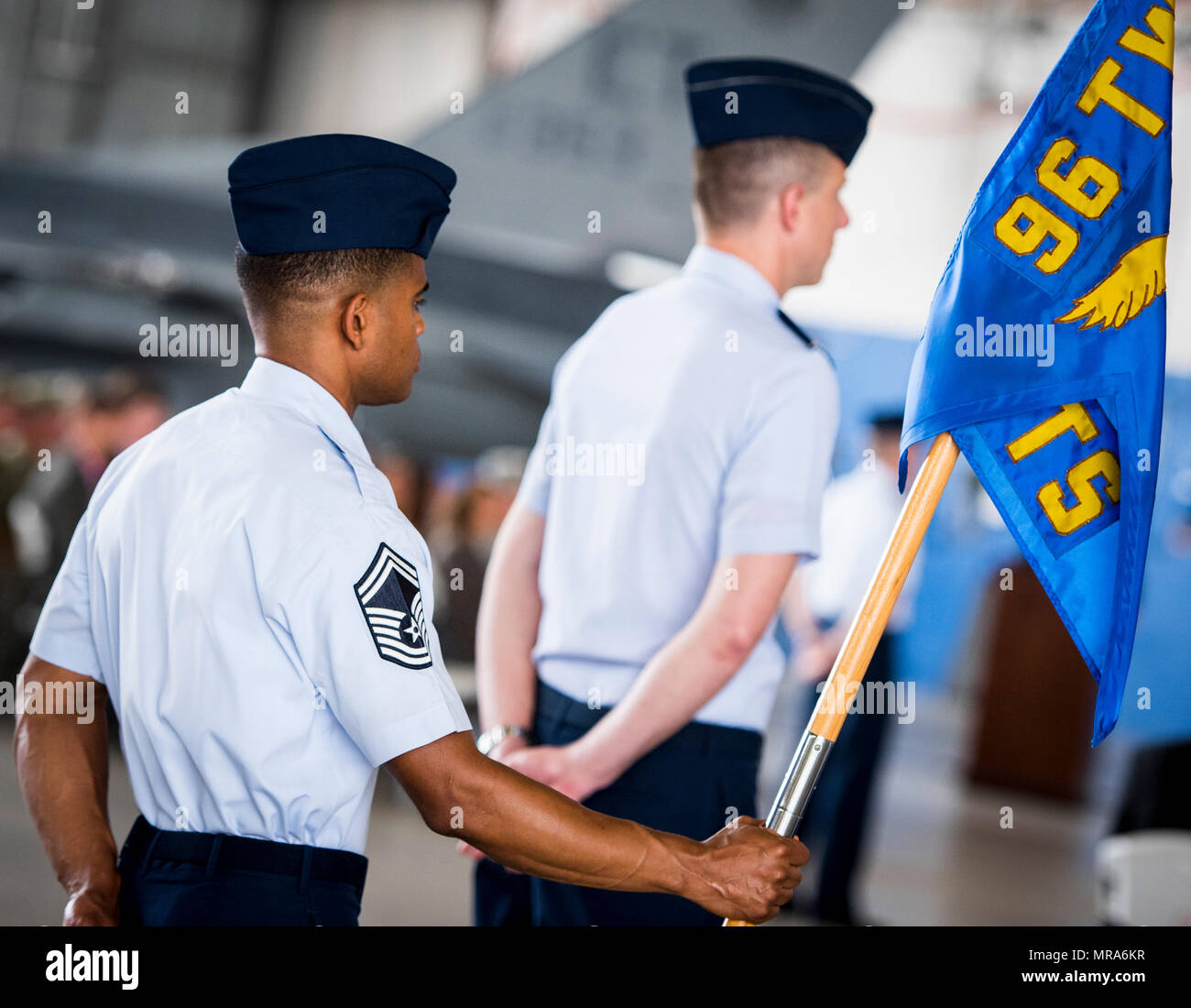 A senior master sergeant holds the 96th Comptroller Squadron guidon ...