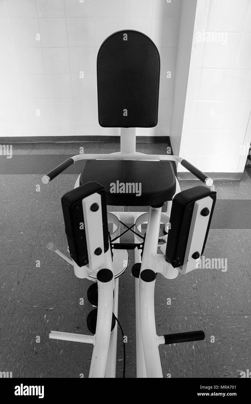 abduction aduction machine indoors gym equipment black white Stock ...