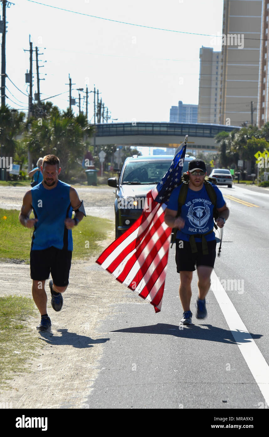 A local runner marches alongside Tech. Sgt. Doug Iredale, a special ...