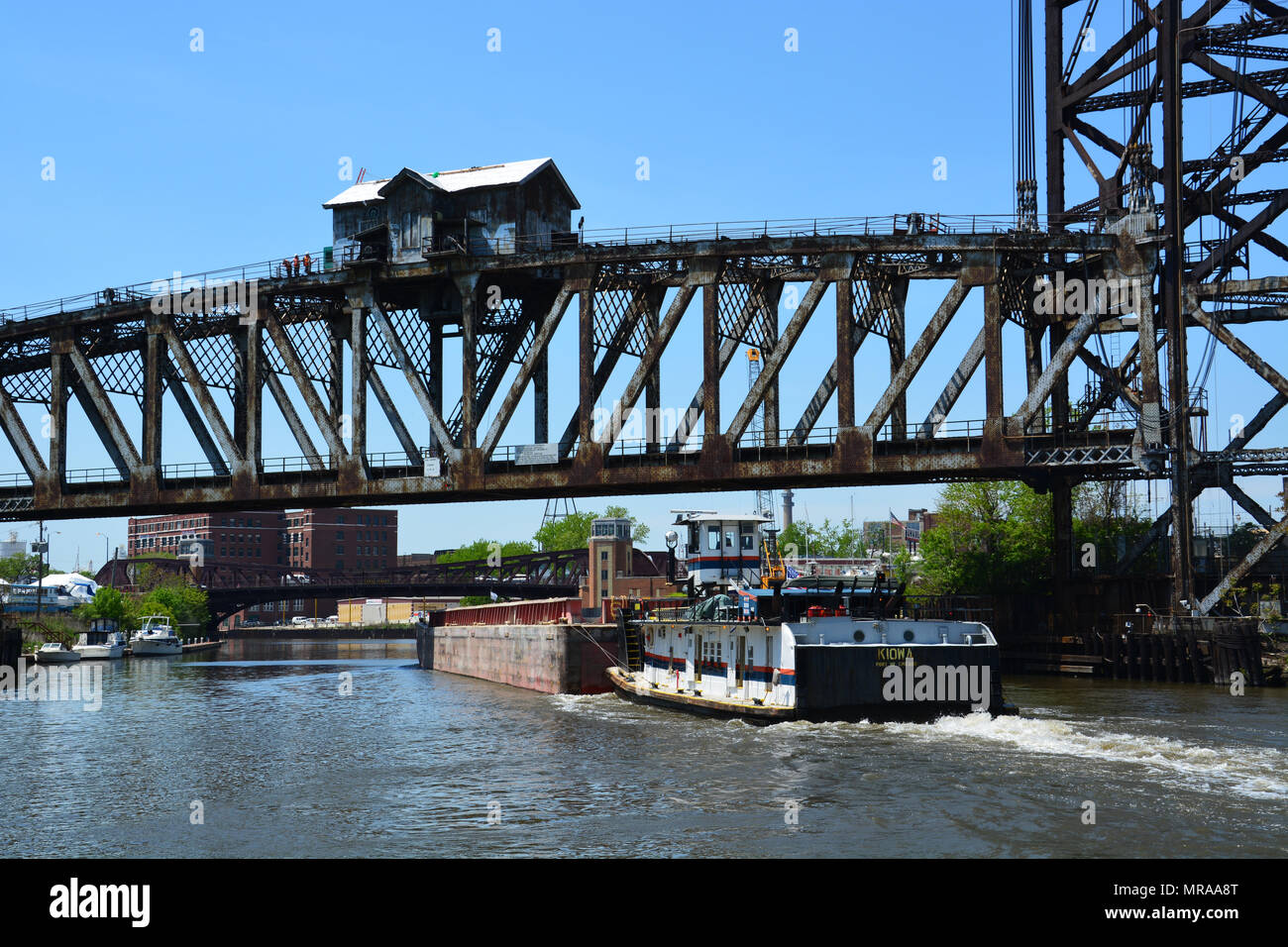 The tugboat Kiowa pushes an empty barge south under the lifted Canal ...