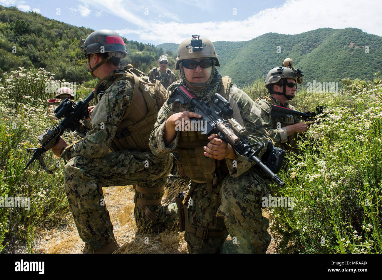 Sailors stand security overwatch while conducting foot patrol drills ...