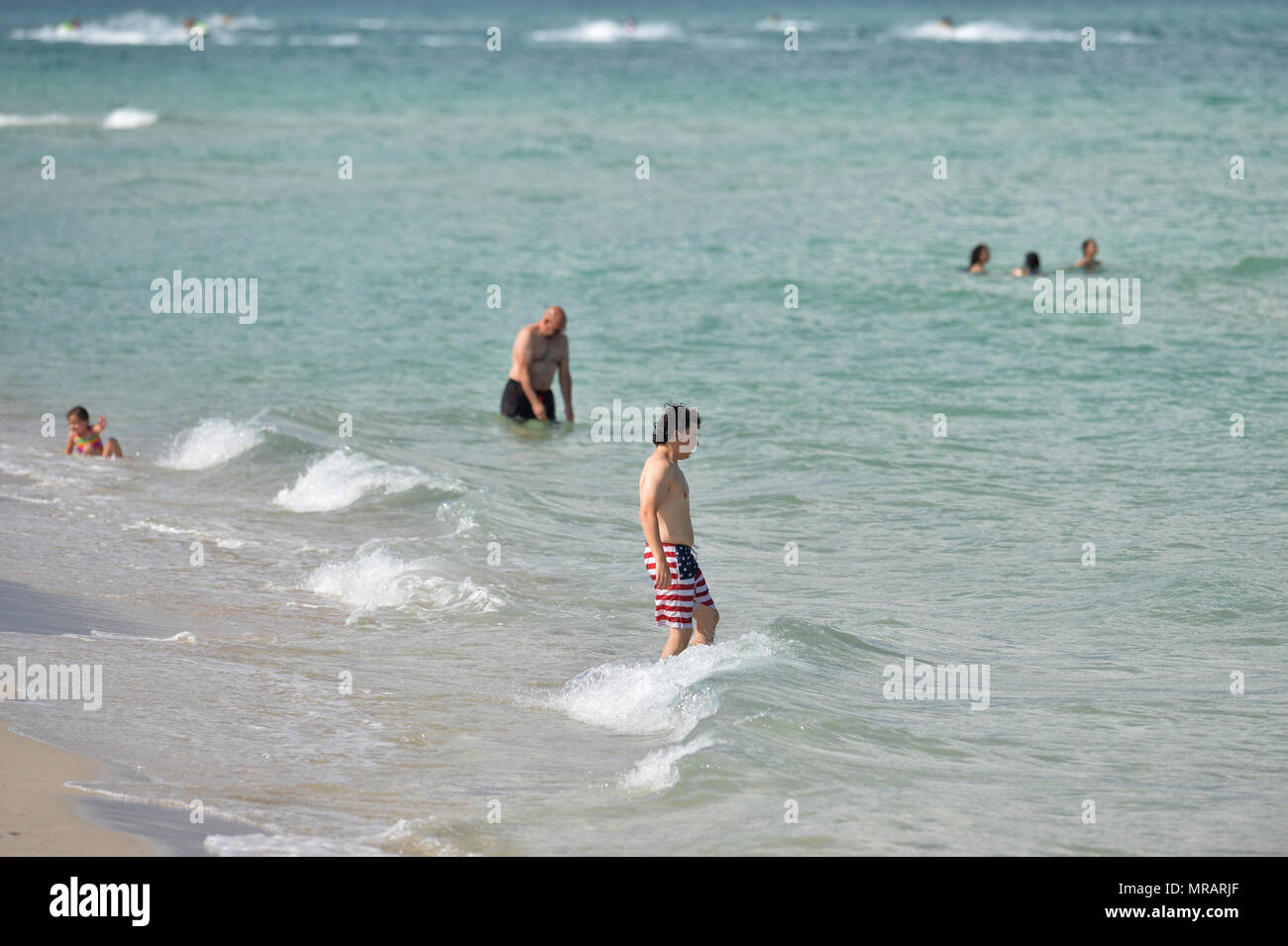 MIAMI BEACH, FL - MAY 14: Actor Jon Bass goes for a swim wearing ...
