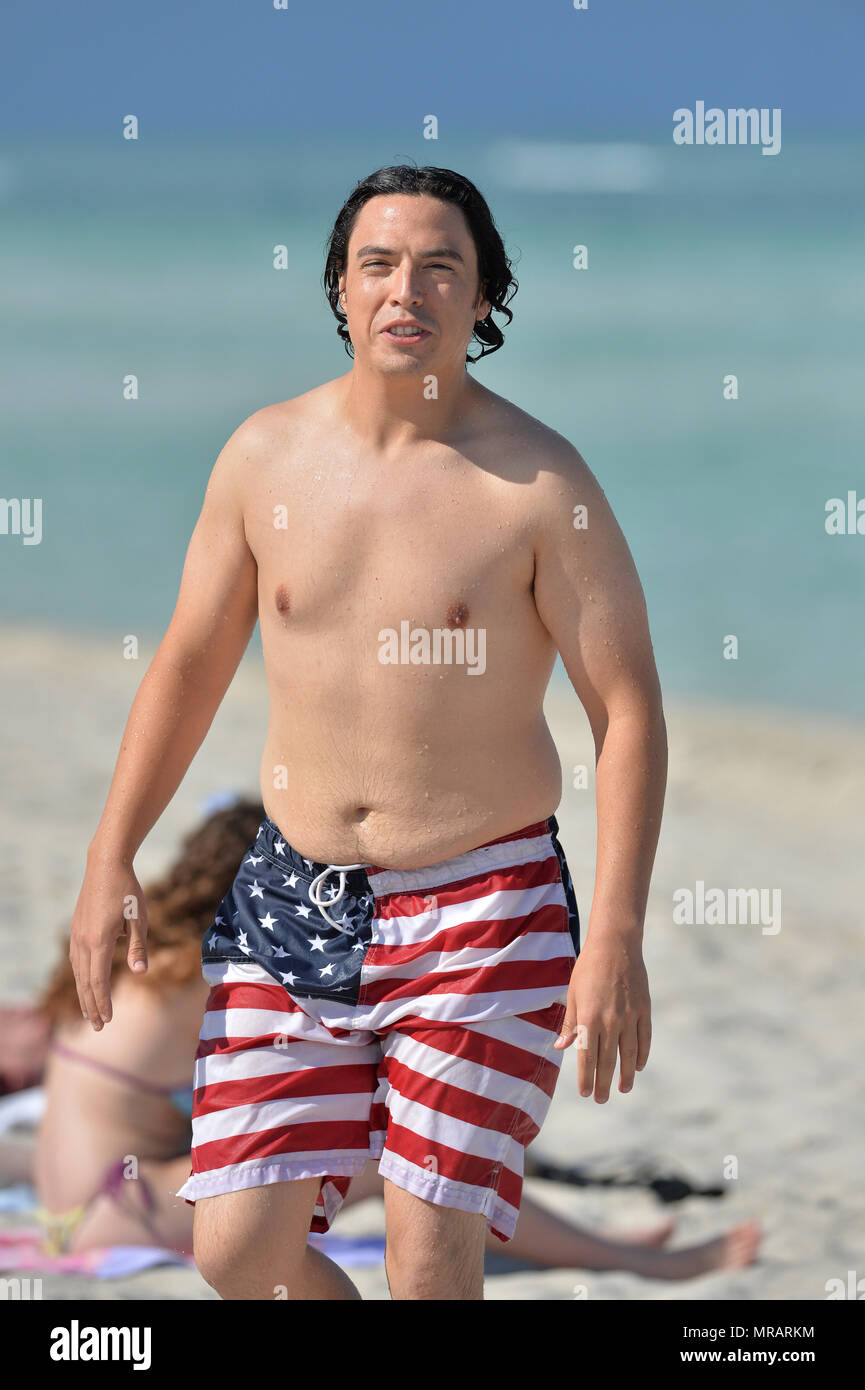 MIAMI BEACH, FL - MAY 14: Actor Jon Bass goes for a swim wearing ...