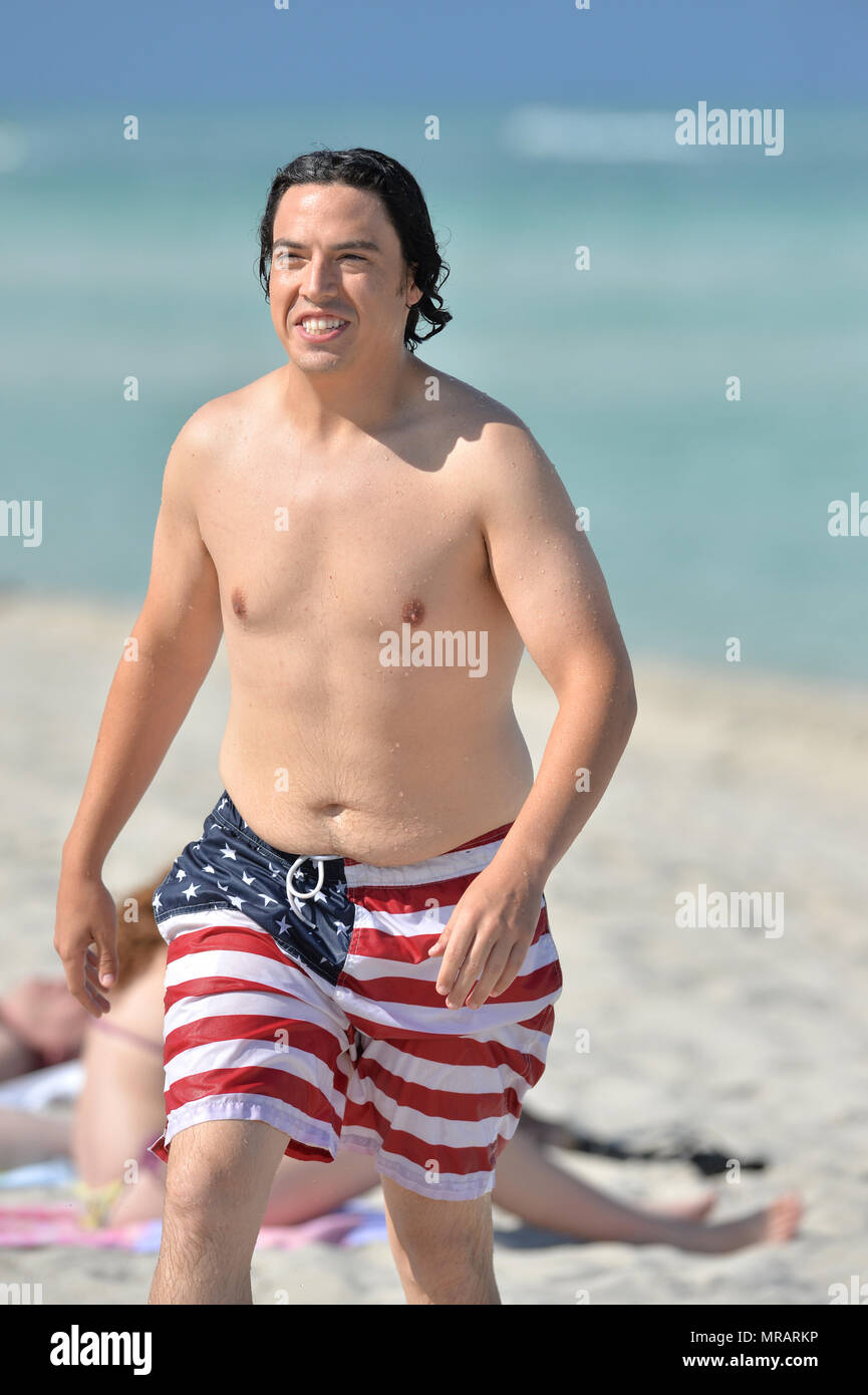 MIAMI BEACH, FL - MAY 14: Actor Jon Bass goes for a swim wearing ...