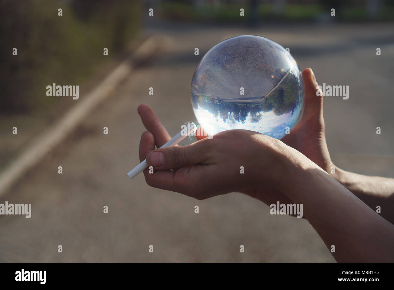 Contact juggling. Hand, acrylic ball and cigarette. Ignition with a ...