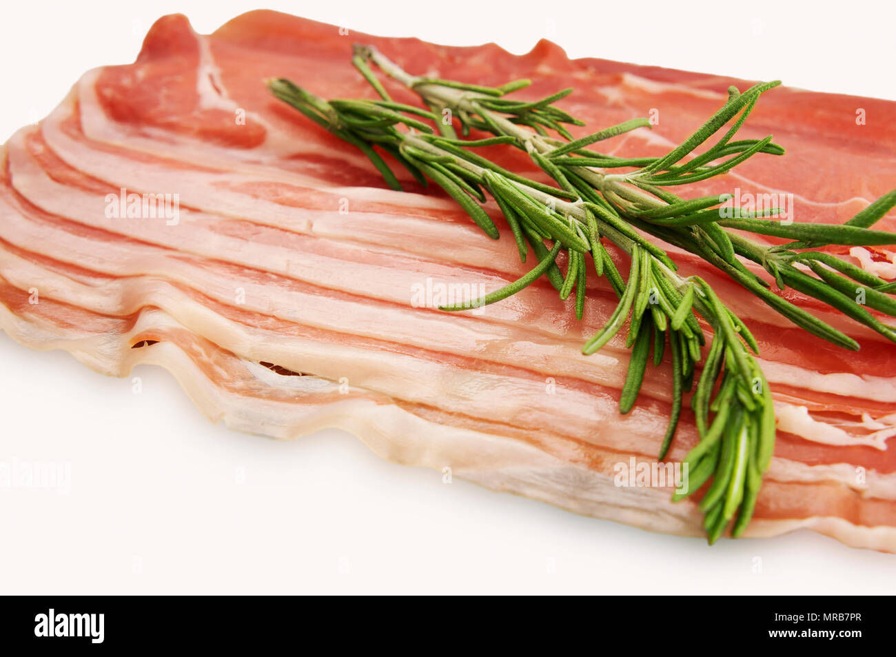 Prosciutto. Smoked pork rashers with rosemary Stock Photo - Alamy