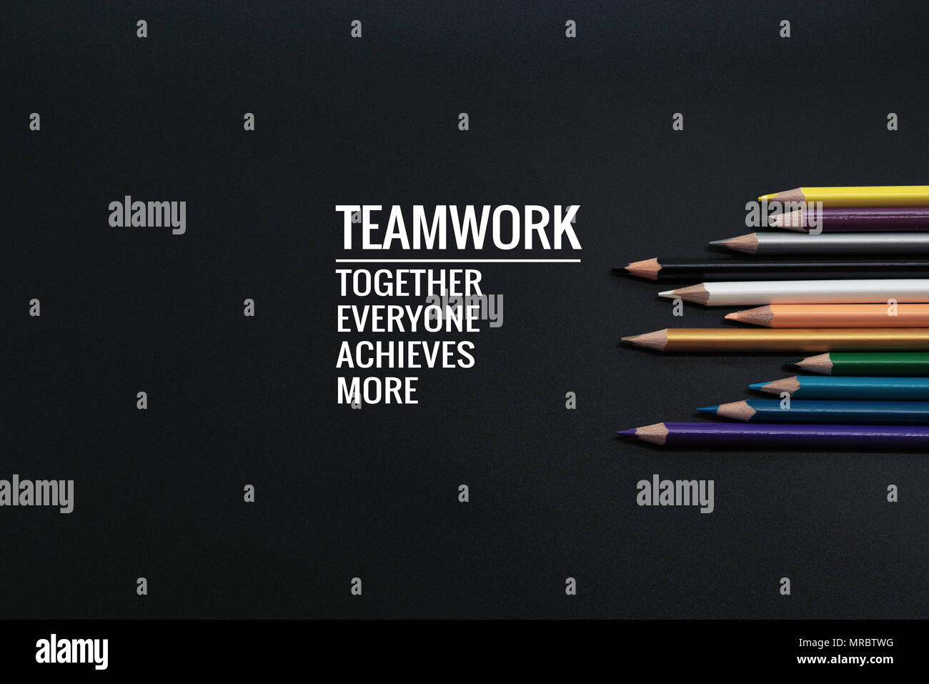 Teamwork concept. group of color pencil on black background with word ...