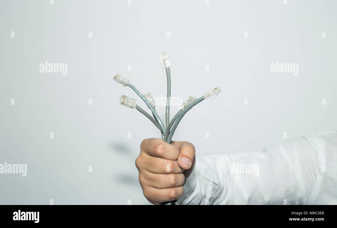 Computer cables in hand on white background Stock Photo - Alamy