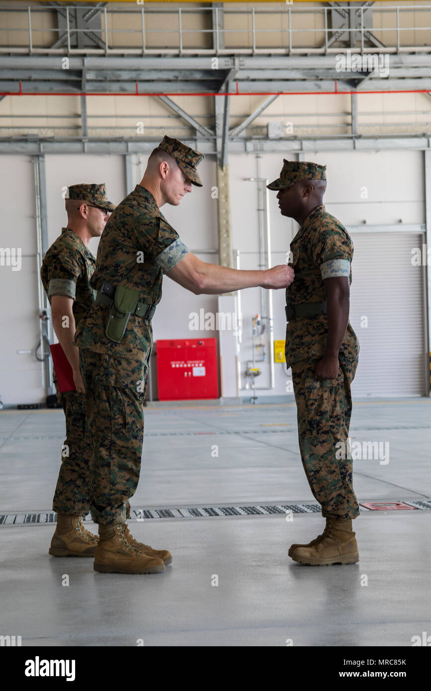 U.S. Marine Corps Lt. Col. Kevin A. Campbell, left, commanding officer of Headquarters and ...