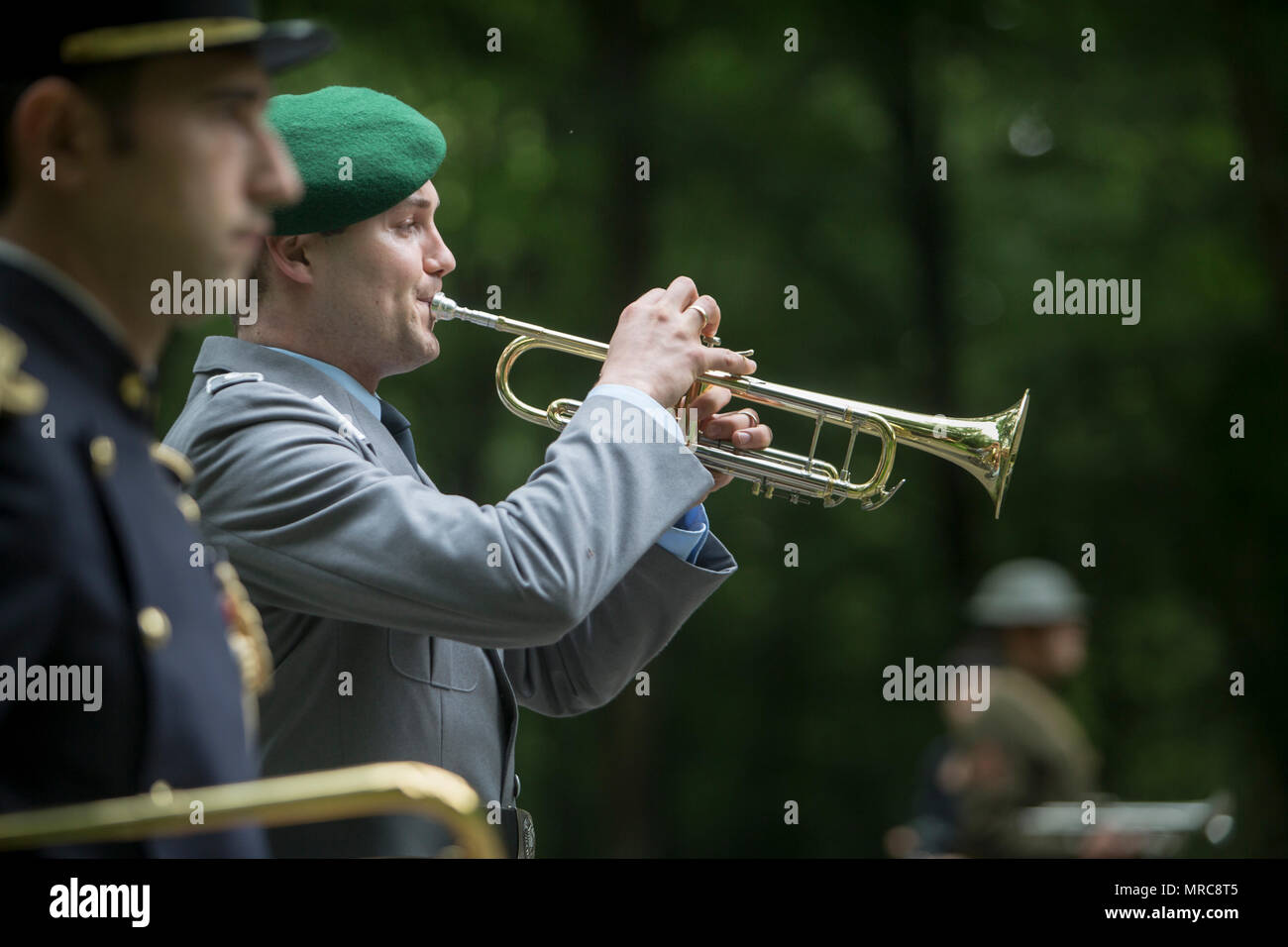 A German Army Buglar plays Taps during a private commemoration ceremony ...