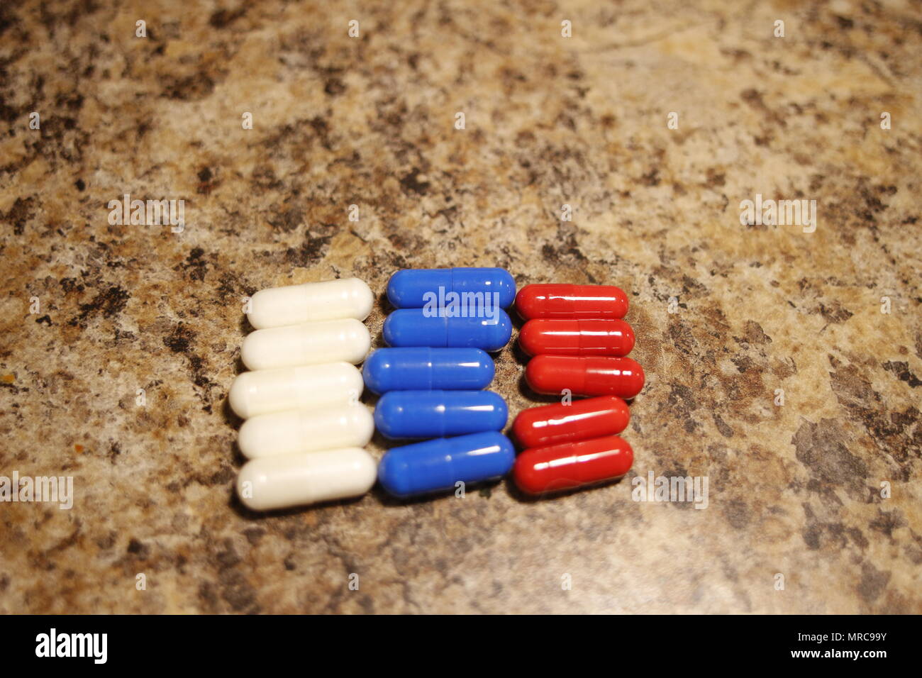 Different pills on light marble background Stock Photo - Alamy