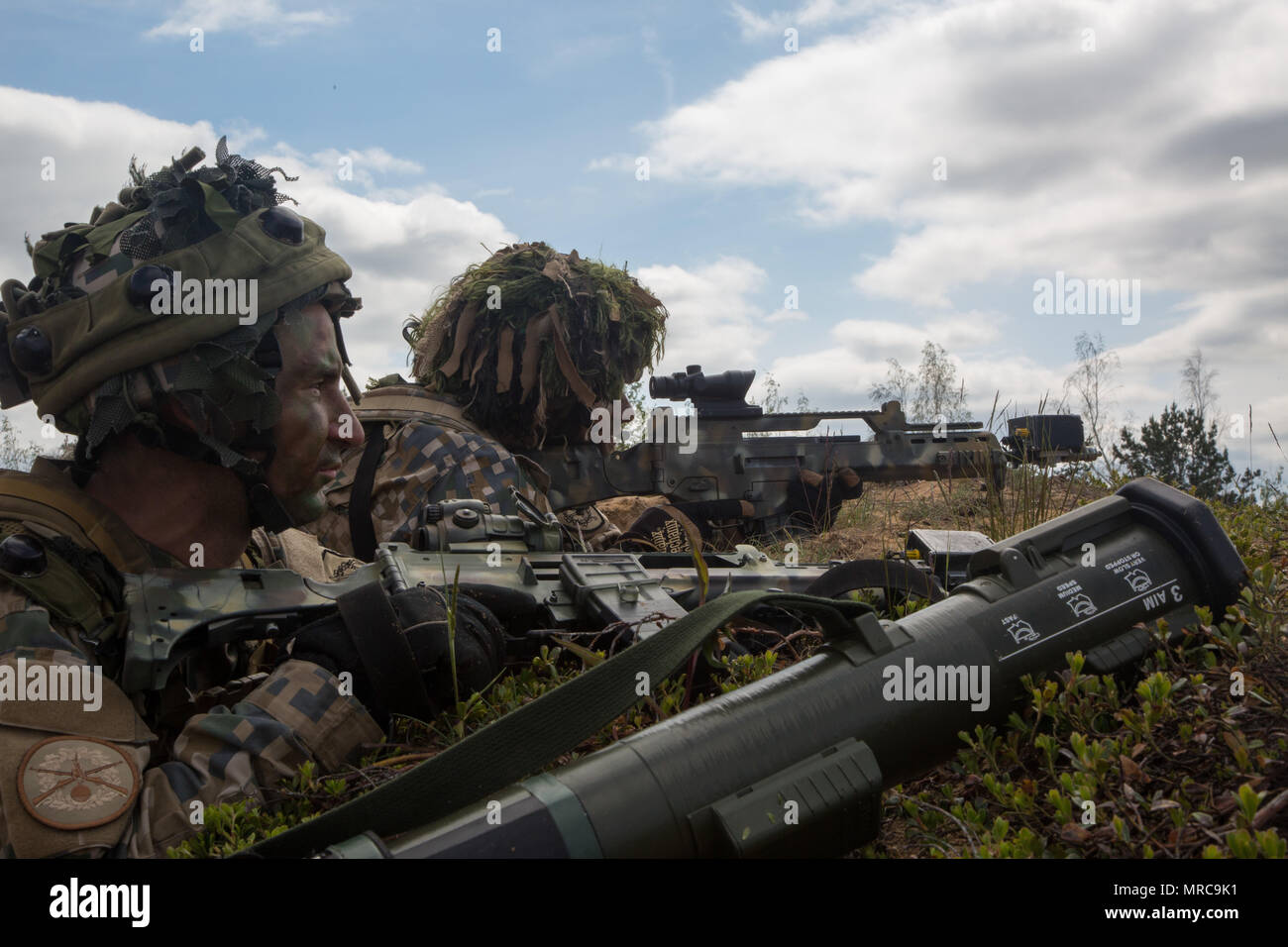 Latvian soldiers, from 2nd Battalion, 3rd Brigade, gaurd a hasty ...