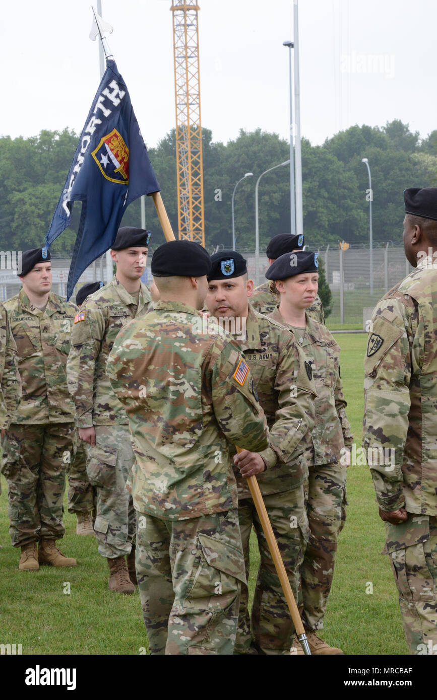 U.S. Army 2nd Lt. Jose M. Marrero-Aguila (incoming), returns the colors ...