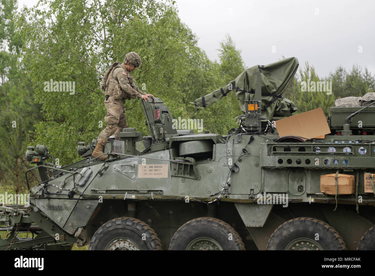 A U.S. soldier takes his place at the driver's hatch of a M1132 ...