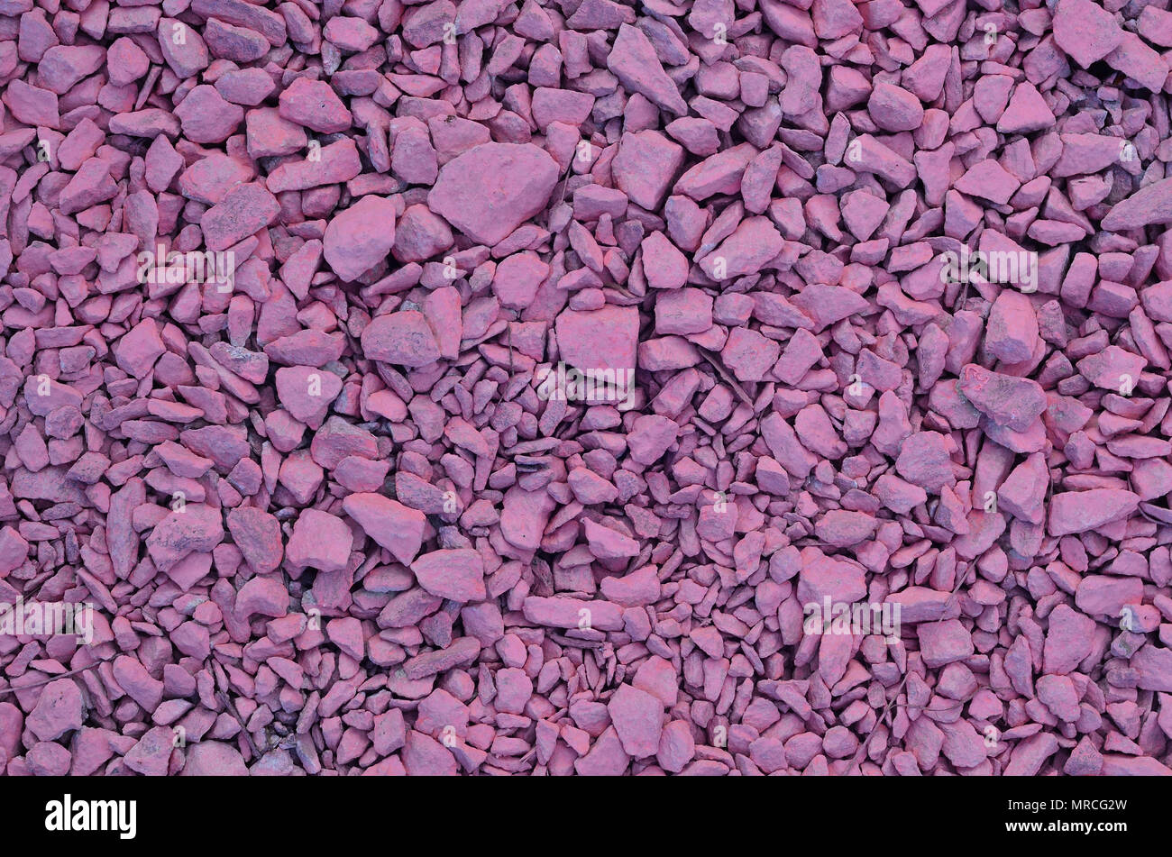 Texture from a pile of crushed stone, painted in light pink color ...