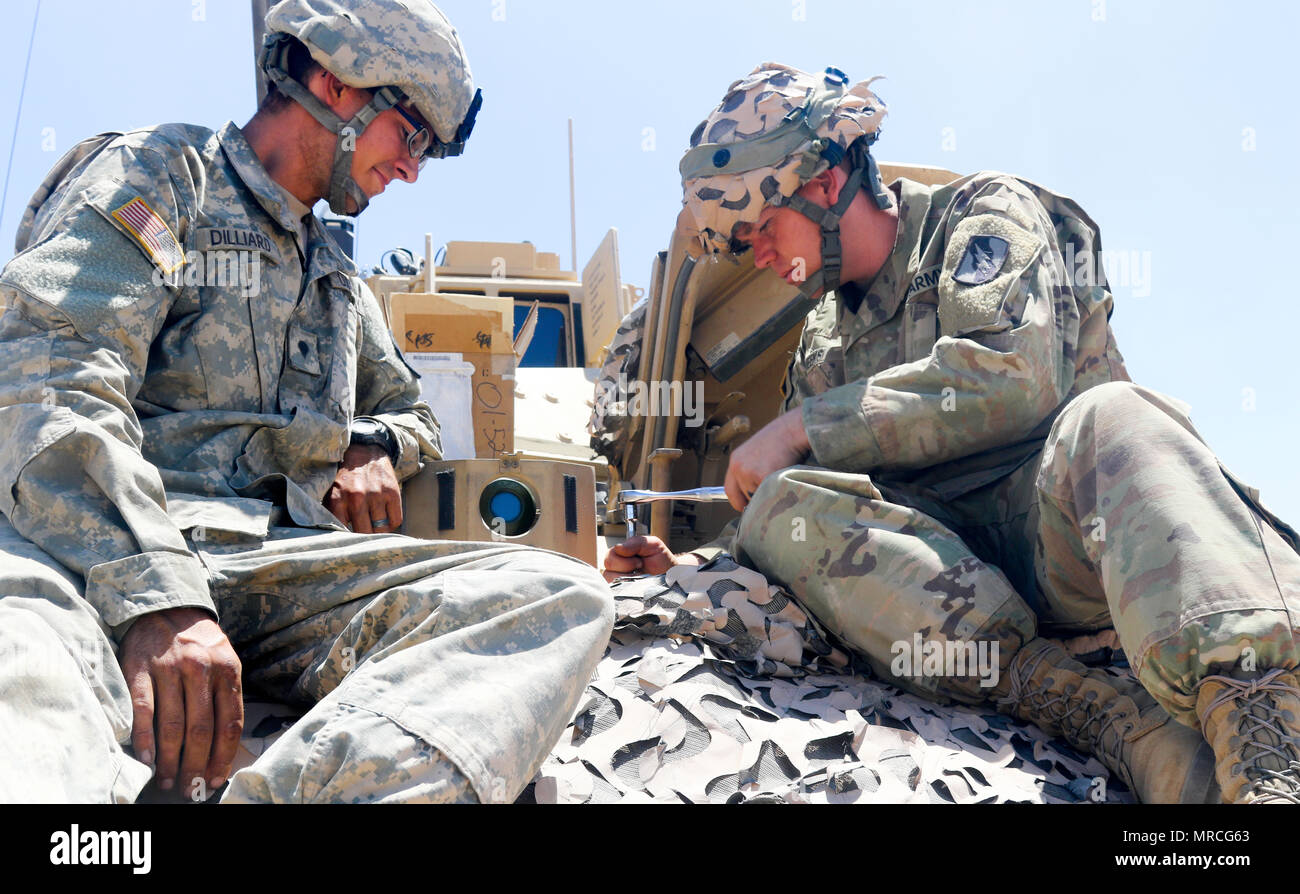 Spc. Johnny W. Dillard and Pfc. Thomas L. Meeks, mechanics with the 1st ...