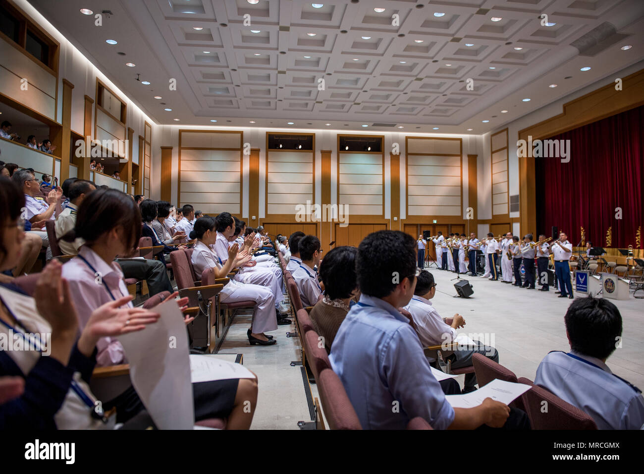 During a concert audience members clap along with the band as they play ...