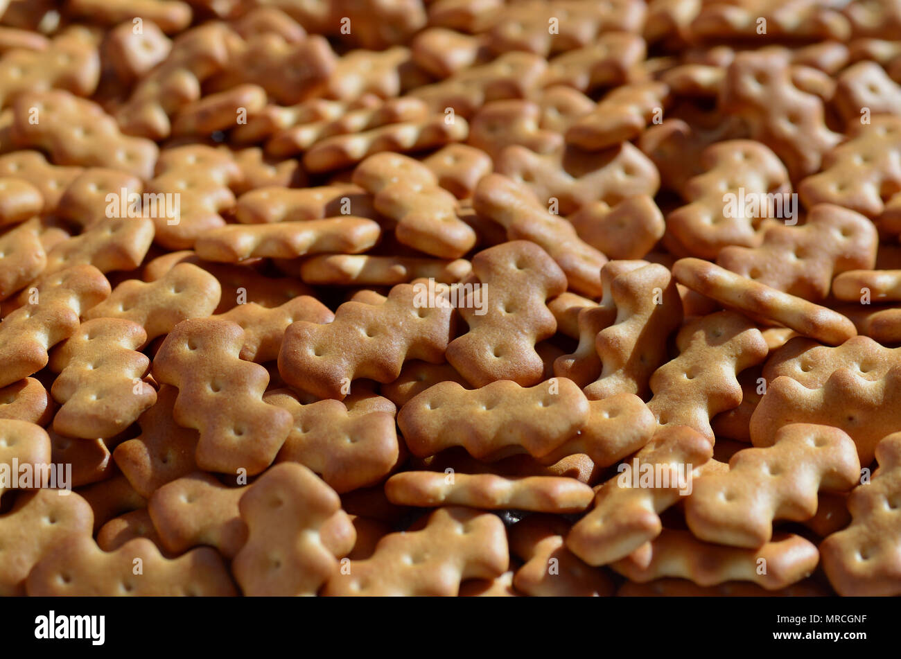 A huge bunch of salted biscuits of small sizes as a closed pattern or ...