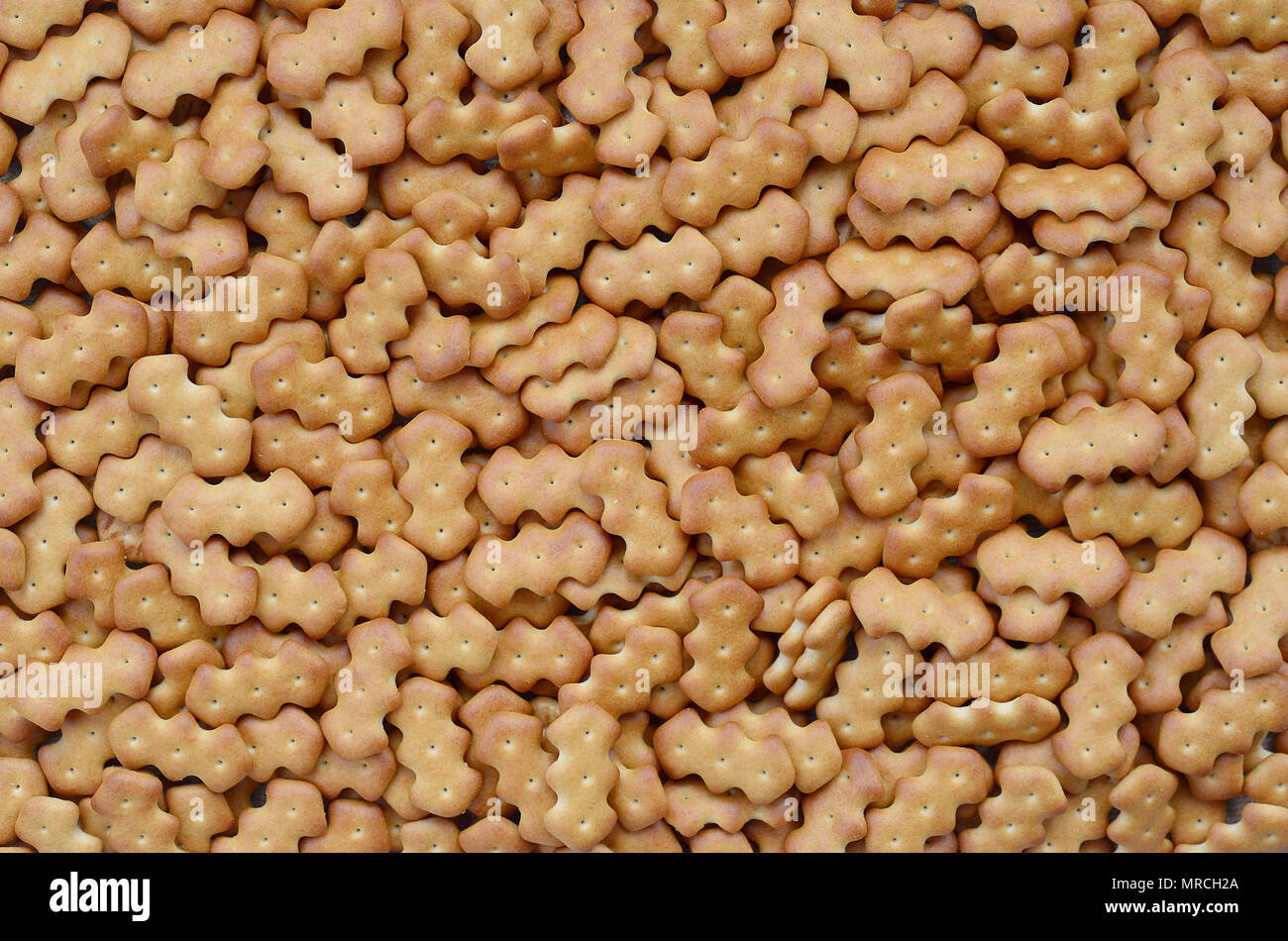 A huge bunch of salted biscuits of small sizes as a closed pattern or ...