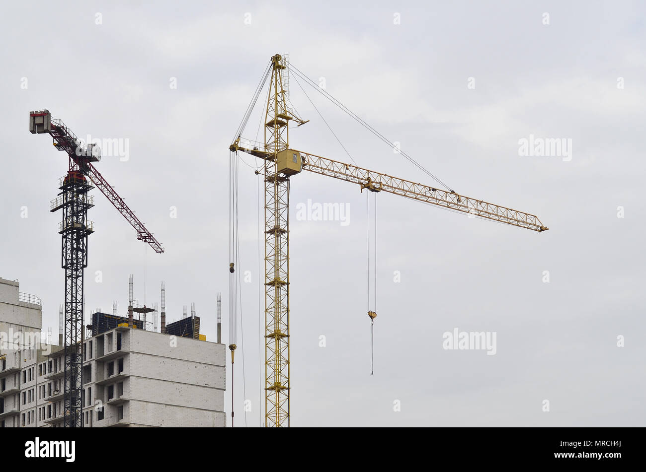 Working tall cranes inside place for with tall buildings under ...