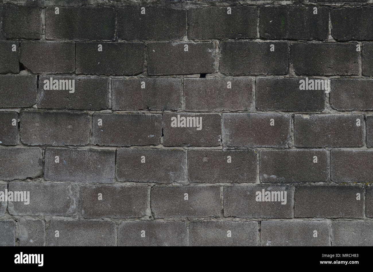 Weathered stained old block wall background. Texture of an old wall of ...