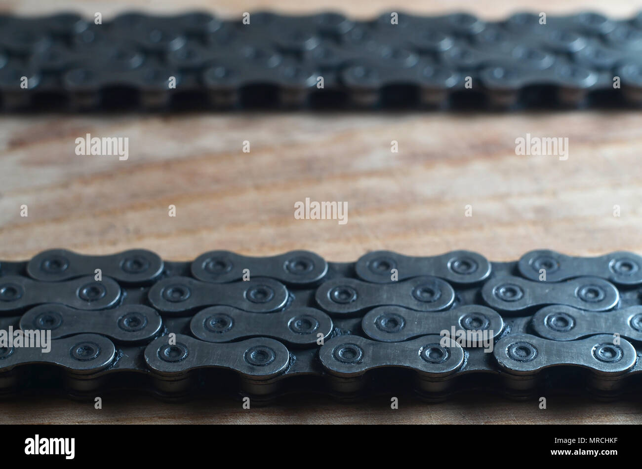 Background image of a chain from a mountain bike lying on a wooden ...