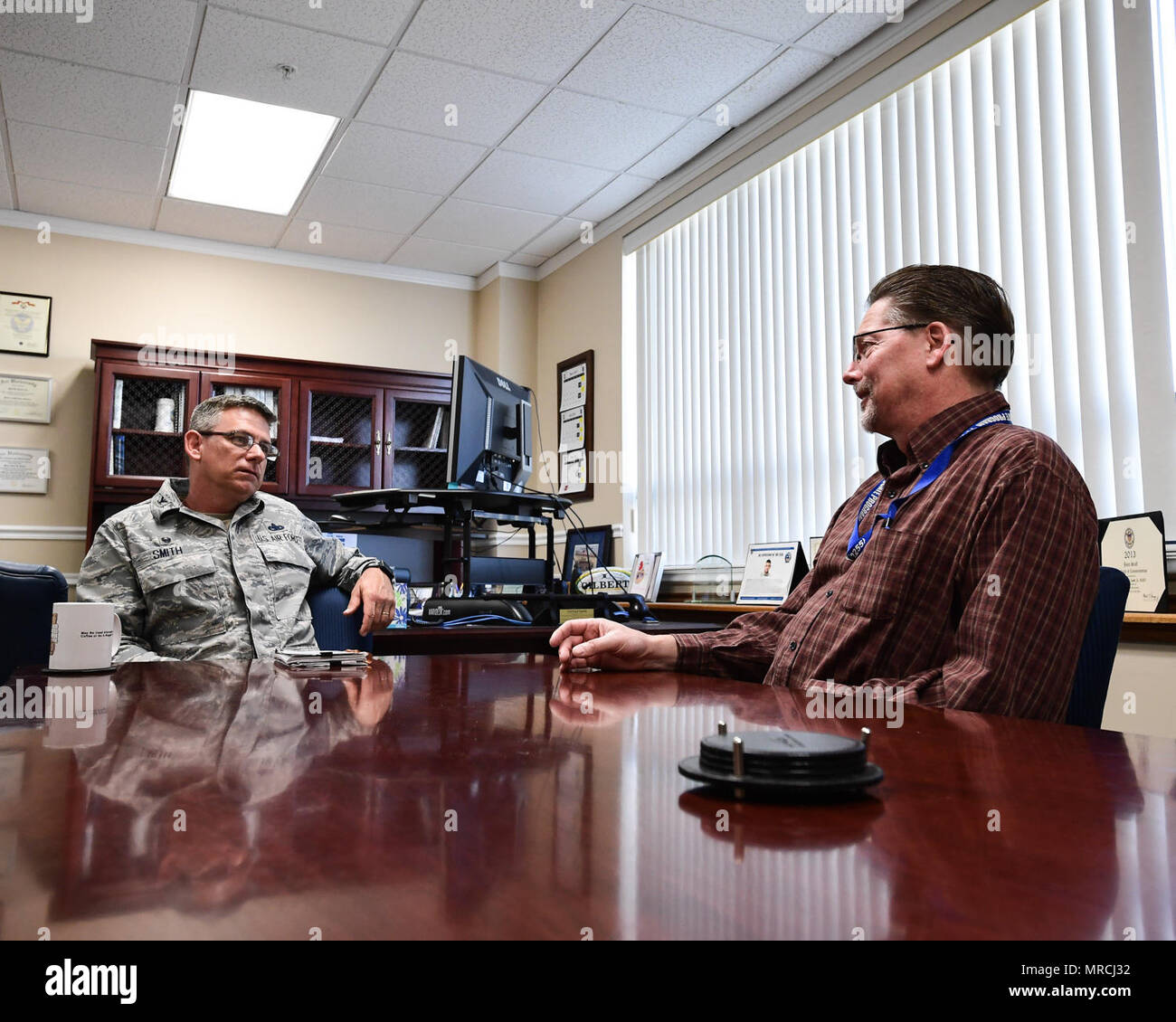 Wingman Advocate Andrew Kalinen talks with his host commander, Col ...