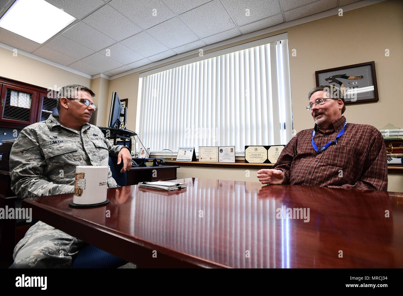 Wingman Advocate Andrew Kalinen talks with his host commander, Col ...
