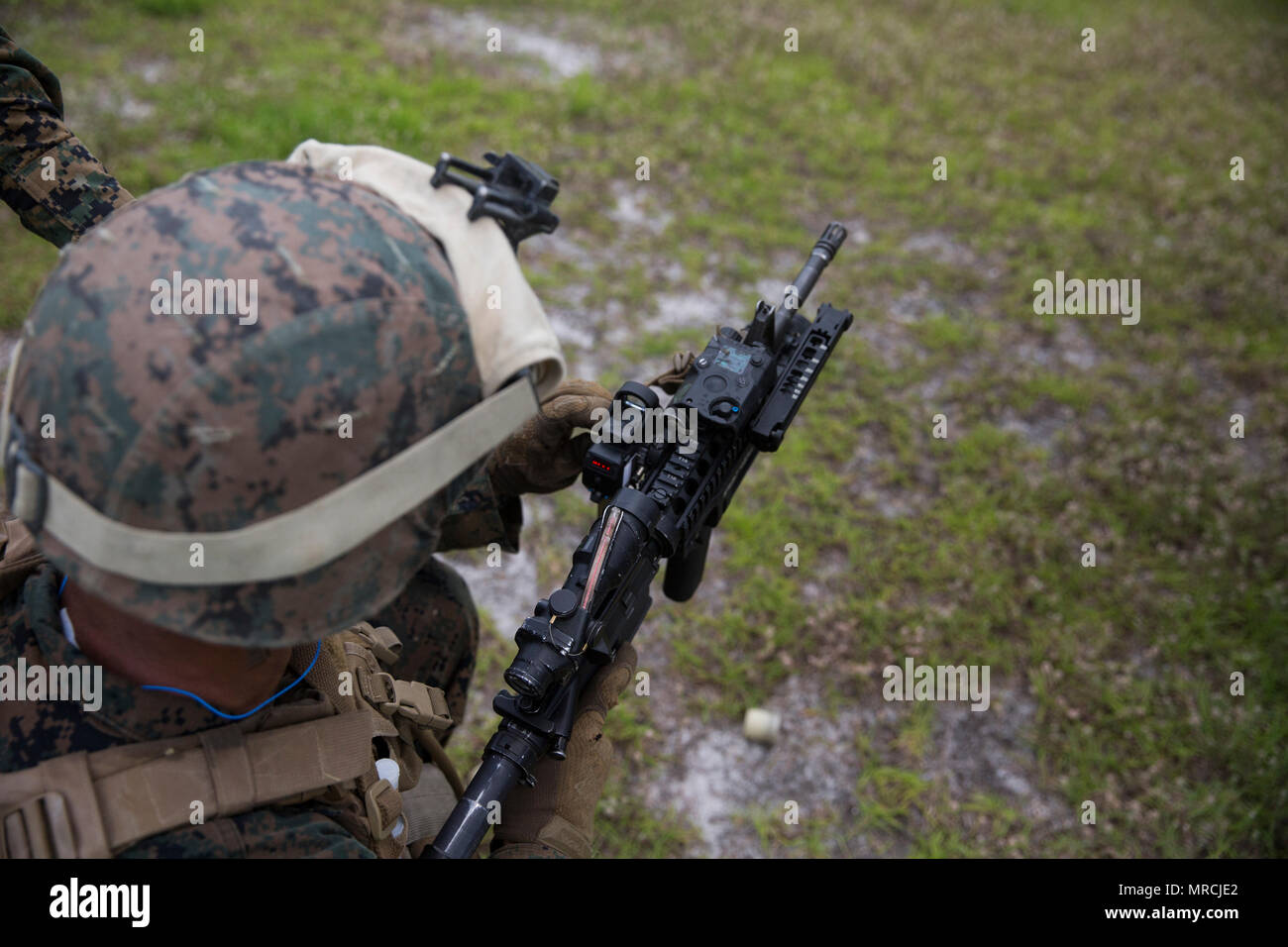 A Marine calibrates the sight on a M320 grenade launcher module mounted ...