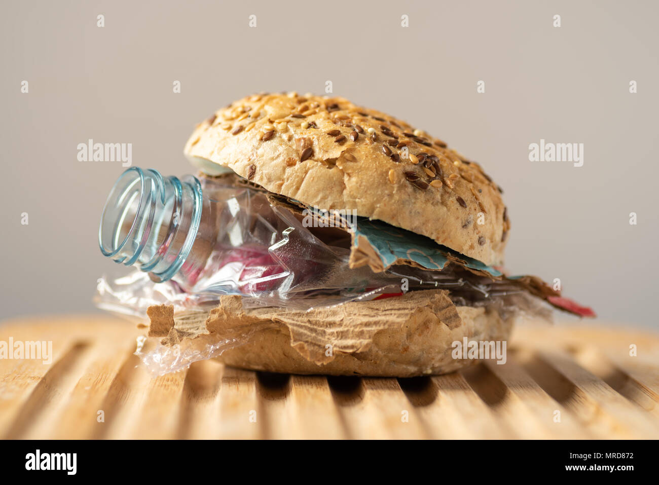 Fresh tasty burger with plastic waste and paper cardboard inside on ...
